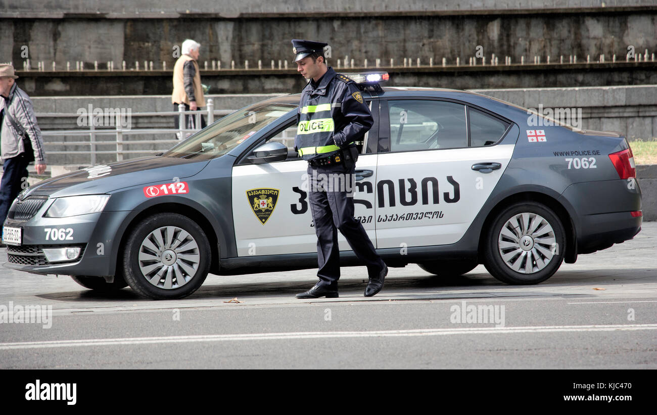Police officer with car in Tbilisi, Georgia Stock Photo - Alamy