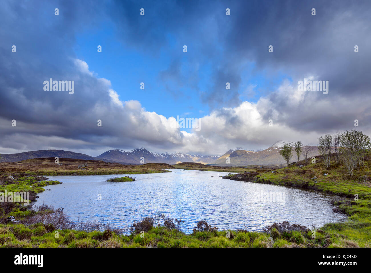 Moor landscape with lake and cloudy sky with mountains in the ...