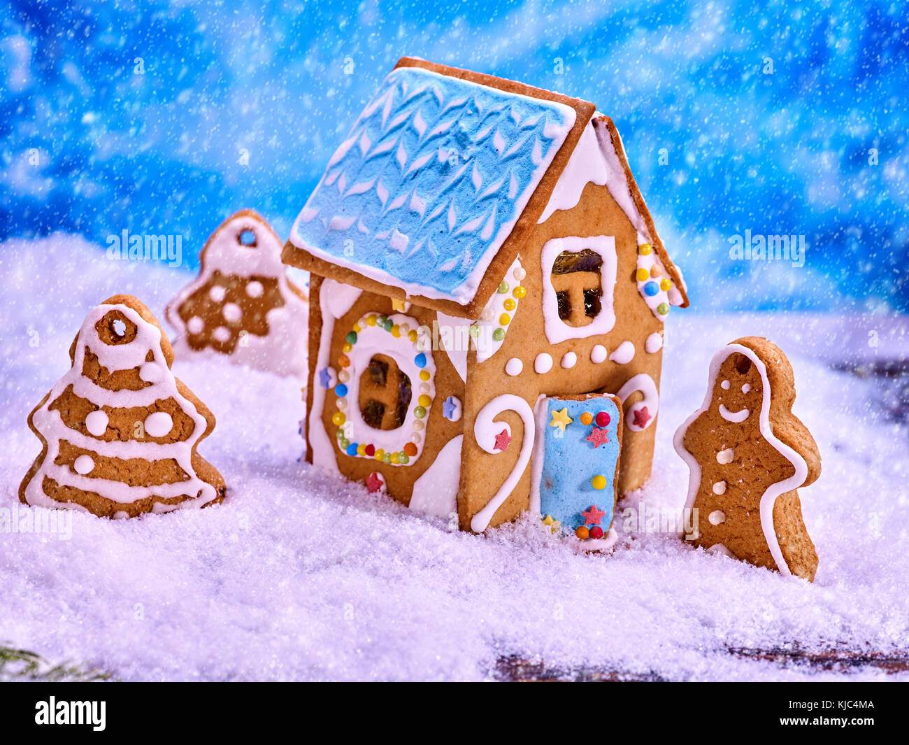 Gingerbread man and Christmas trees cookies in snow Stock Photo - Alamy