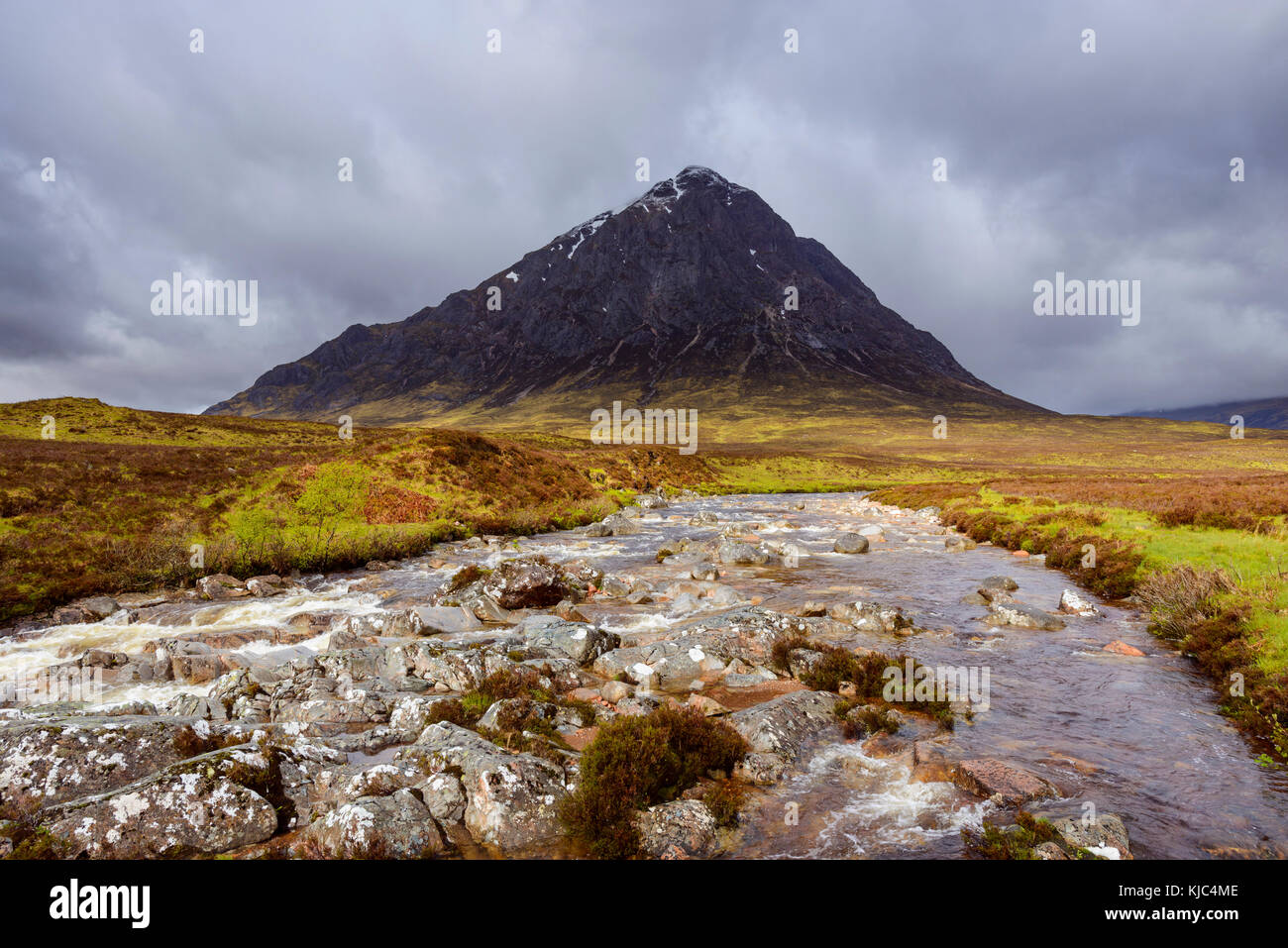 River Etive and mountain range Buachaille Etive Mor with dark cloudy ...