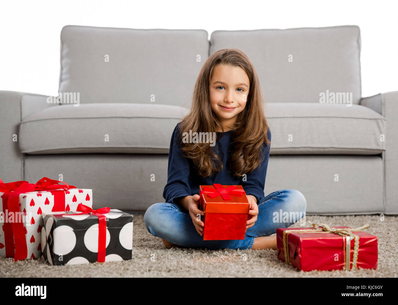 Happy little girl at home opening Christmas presents Stock Photo - Alamy