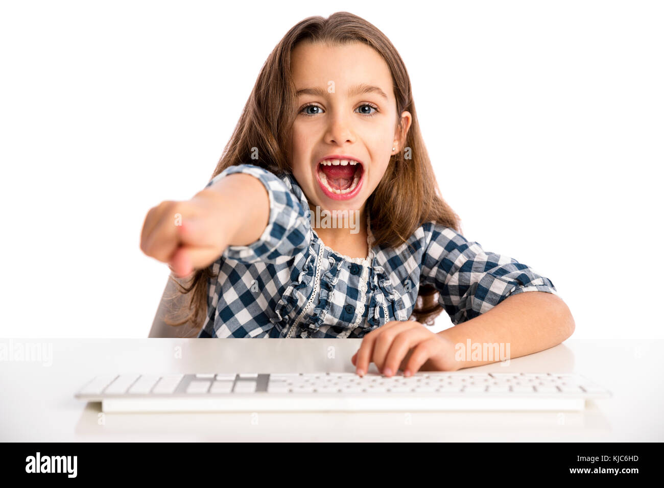 Little girl sitting on a desk and working with a computer Stock Photo ...