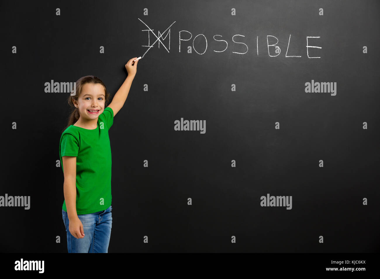 Smart little girl writing in a blackboard, with copy space Stock Photo ...