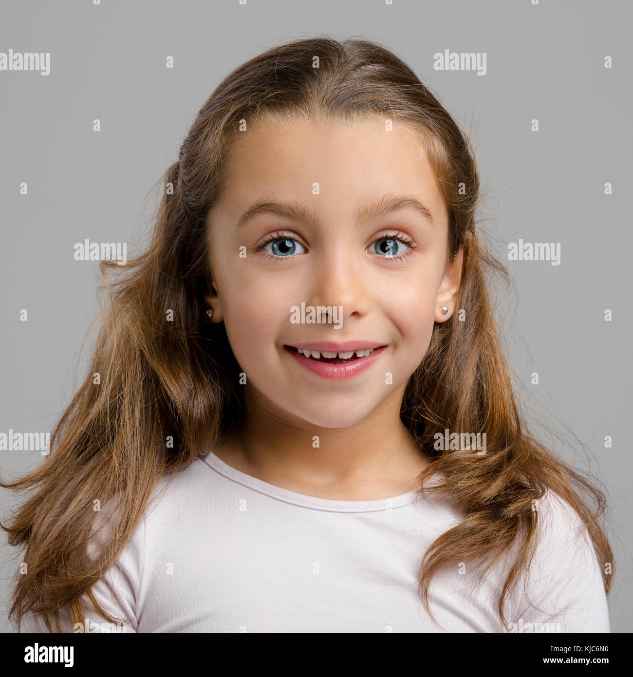 Portrait of a little girl with a smiling expression Stock Photo - Alamy