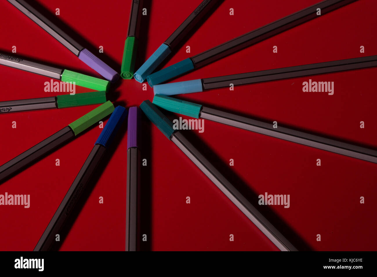 Fine line coloured pens on red background Stock Photo - Alamy