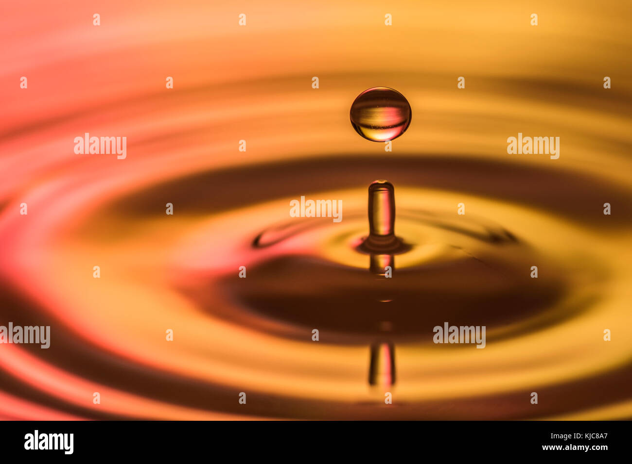 Water drop falling on water surface Stock Photo - Alamy