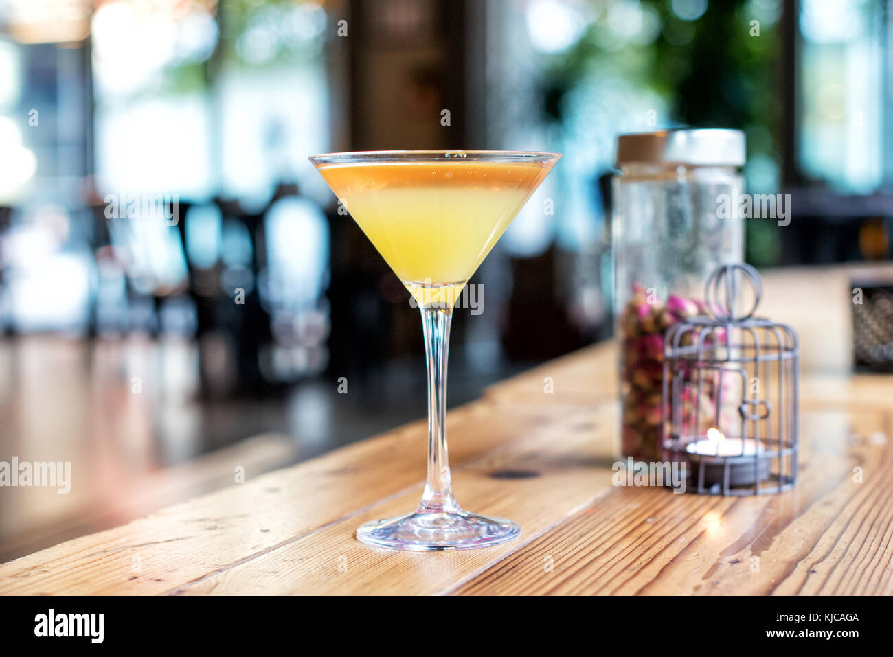Close-up of a sweet yellow alcoholic cocktail in a stemmed glass on ...