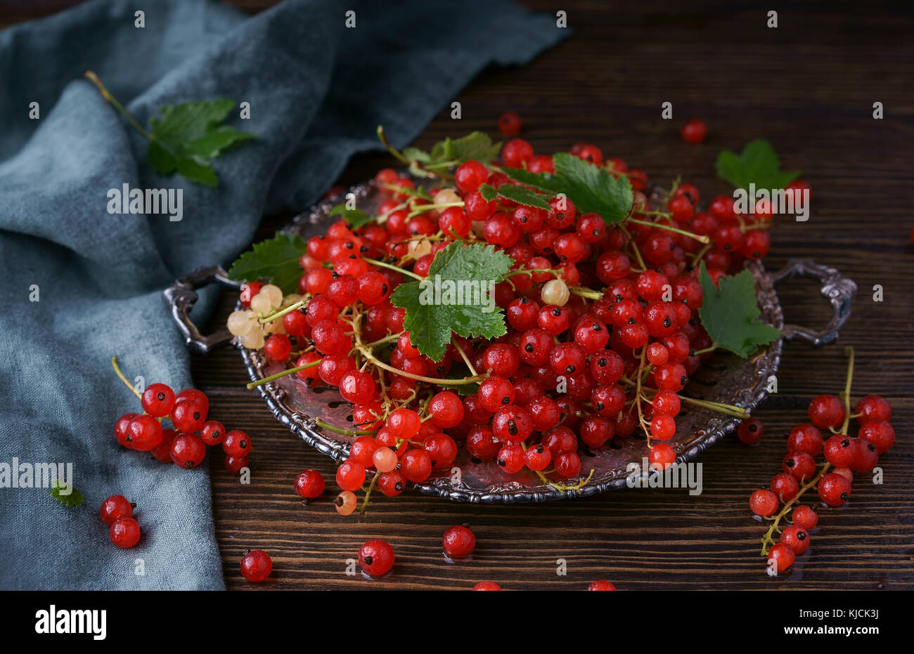Red berries and leaves on tray Stock Photo - Alamy