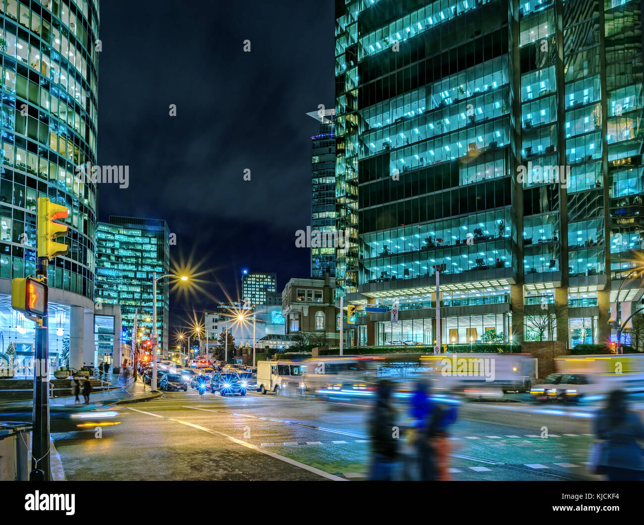 downtown at big metropolis at night with a traffic light, car ...