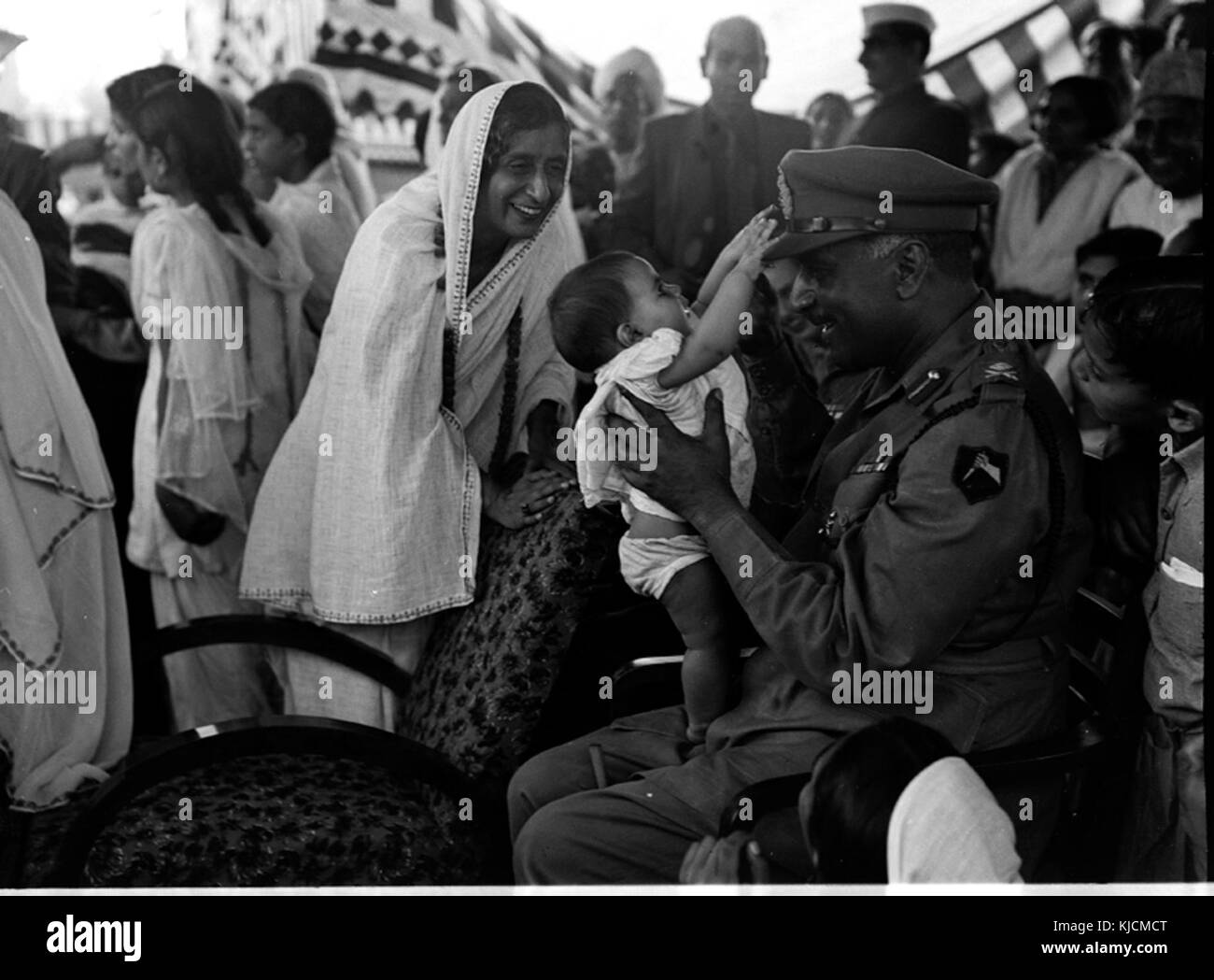 This image shows a baby playfully trying to remove the cap of Major ...