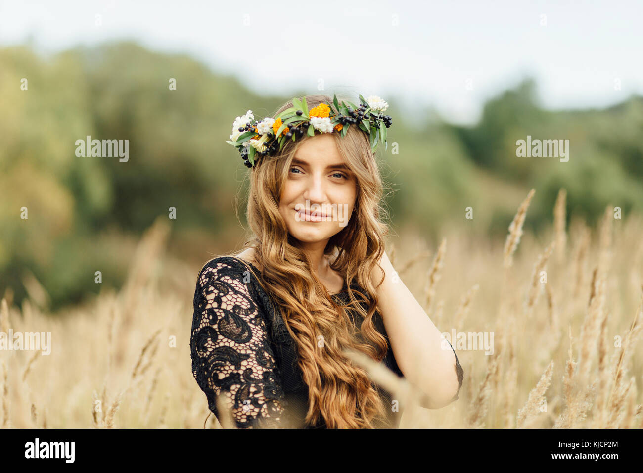 Middle Eastern woman wearing flower crown in field Stock Photo - Alamy