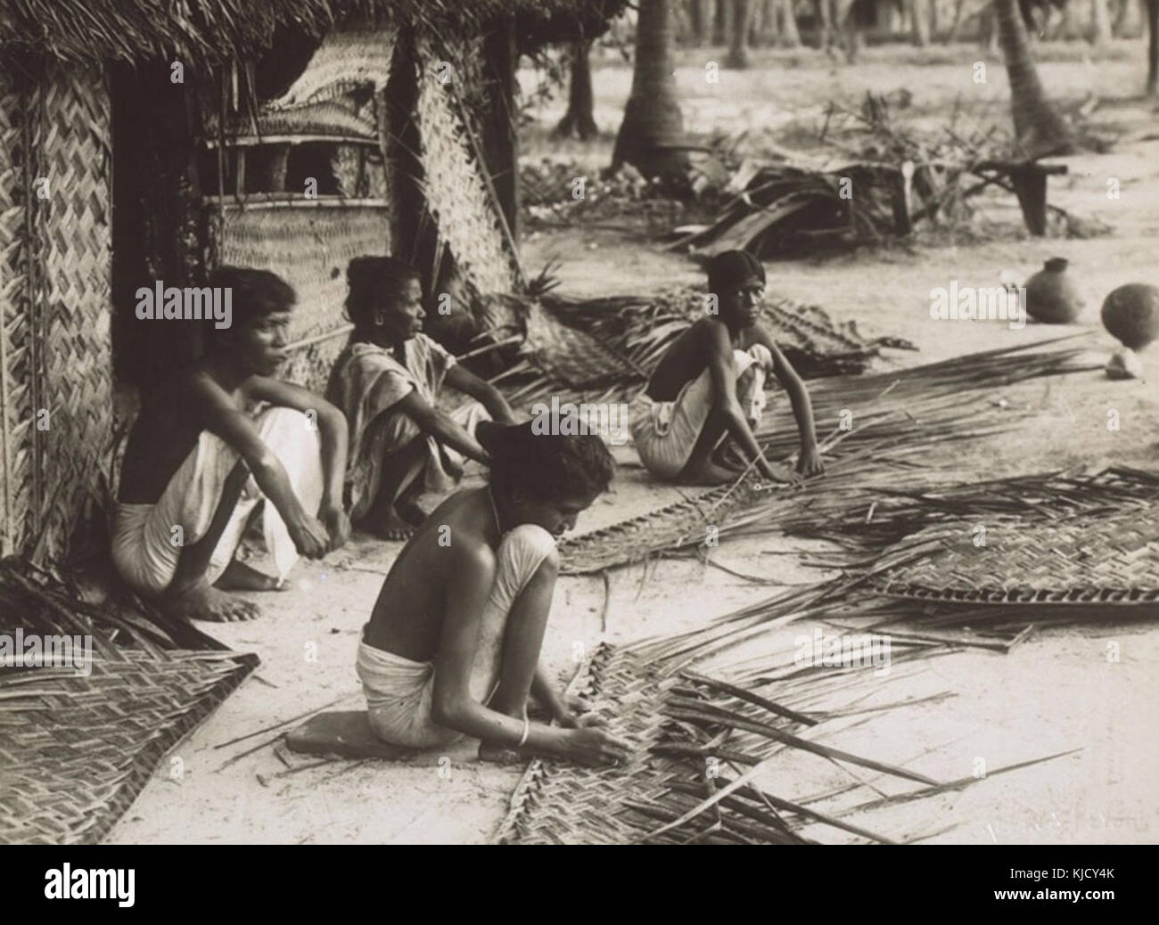 This 1921 photograph shows the traditional craft of weaving coconut ...
