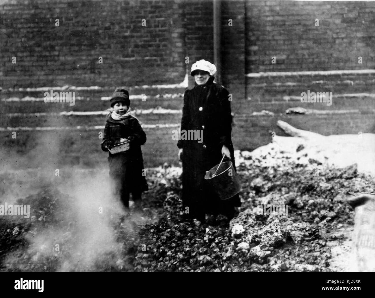 Child and adult collecting coal or coke Stock Photo - Alamy