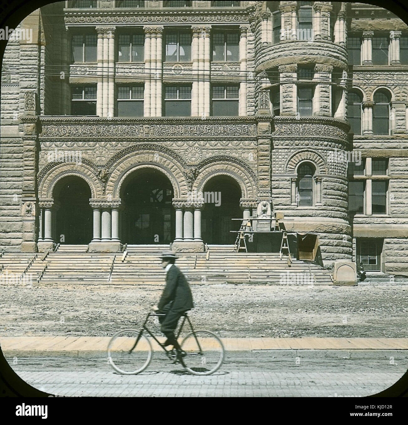 Cyclist passing city hall Stock Photo - Alamy