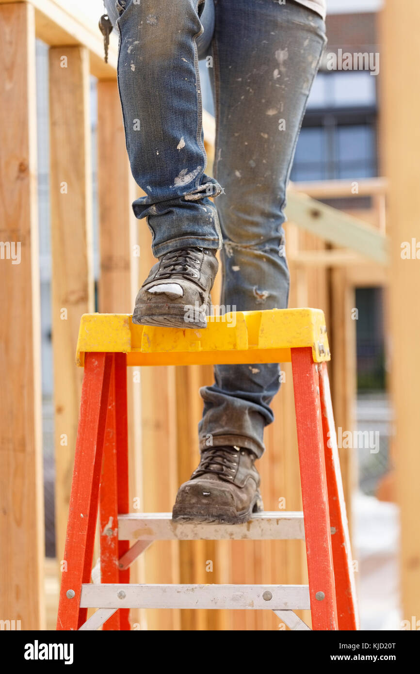 Legs of Caucasian woman on ladder at construction site Stock Photo - Alamy