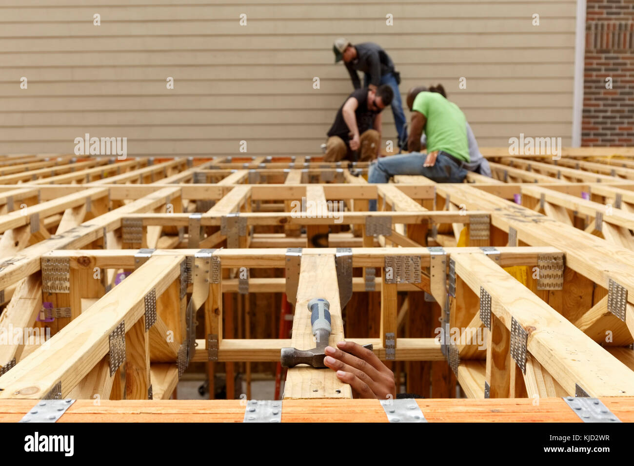 Hand reaching for hammer on the roof at construction site Stock Photo ...