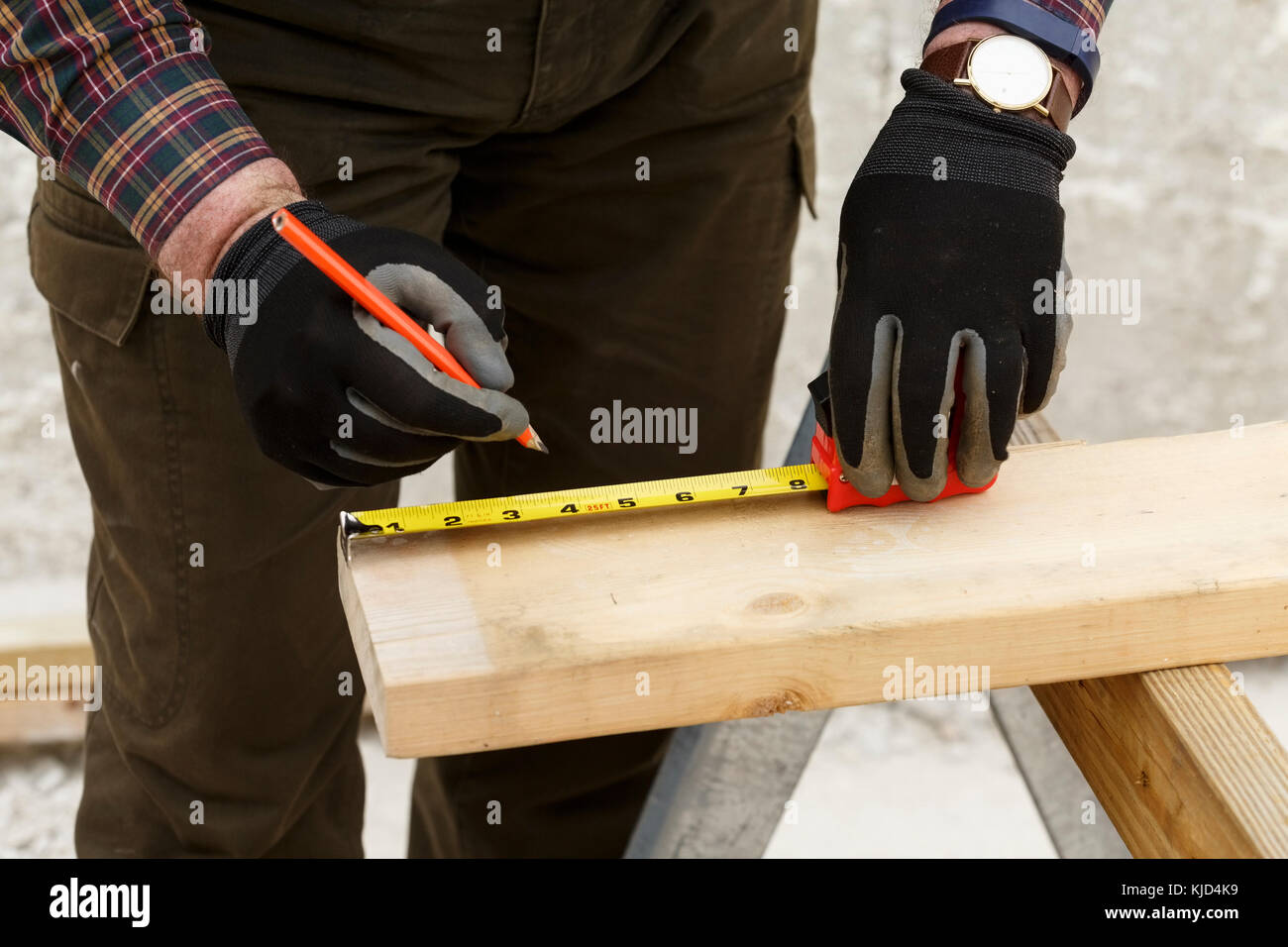Caucasian man measuring lumber Stock Photo - Alamy