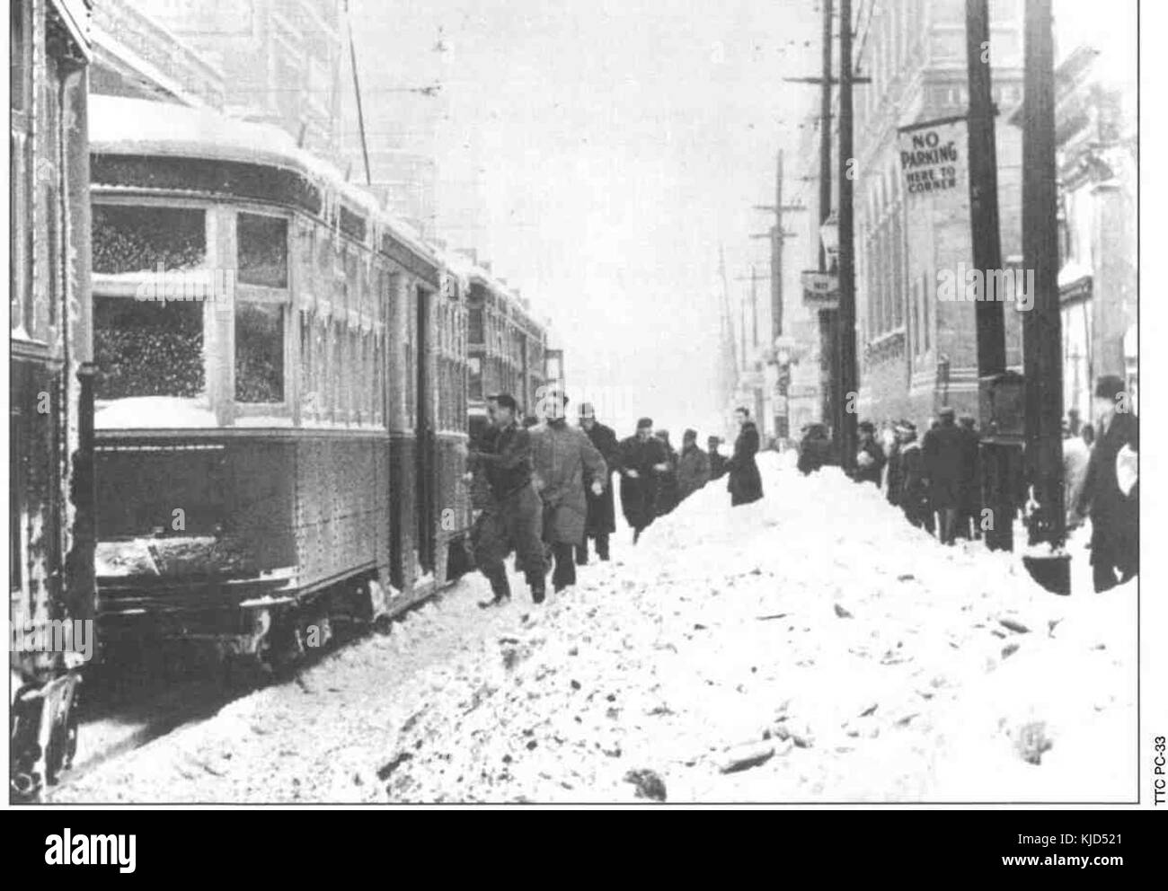 Passengers board northbound streetcars at Yonge and King on a snowy day ...
