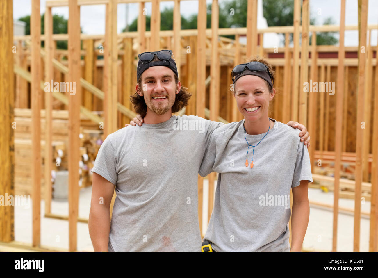 Caucasian man and woman posing at construction site Stock Photo - Alamy