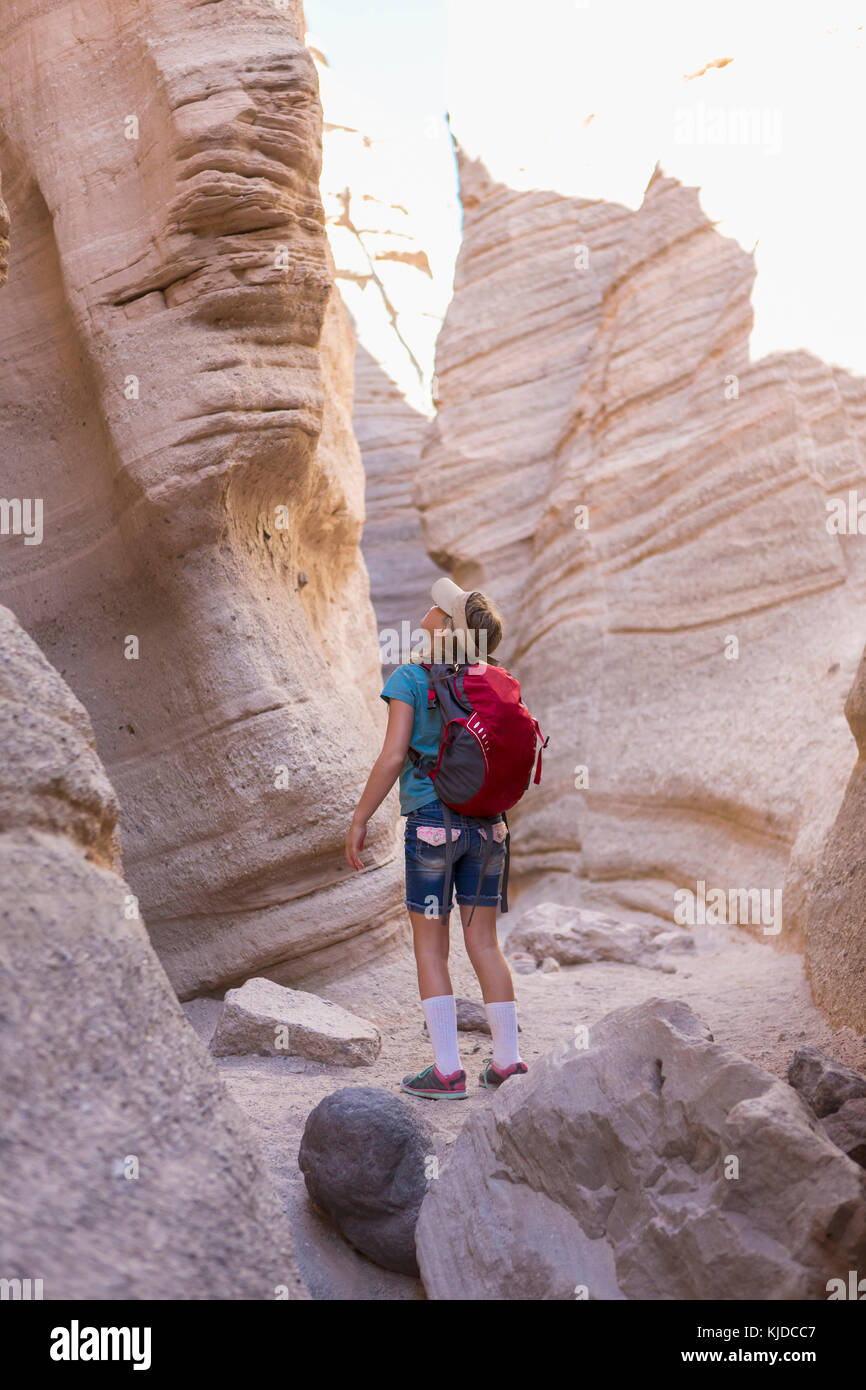 Caucasian girl looking up at rock formation Stock Photo - Alamy
