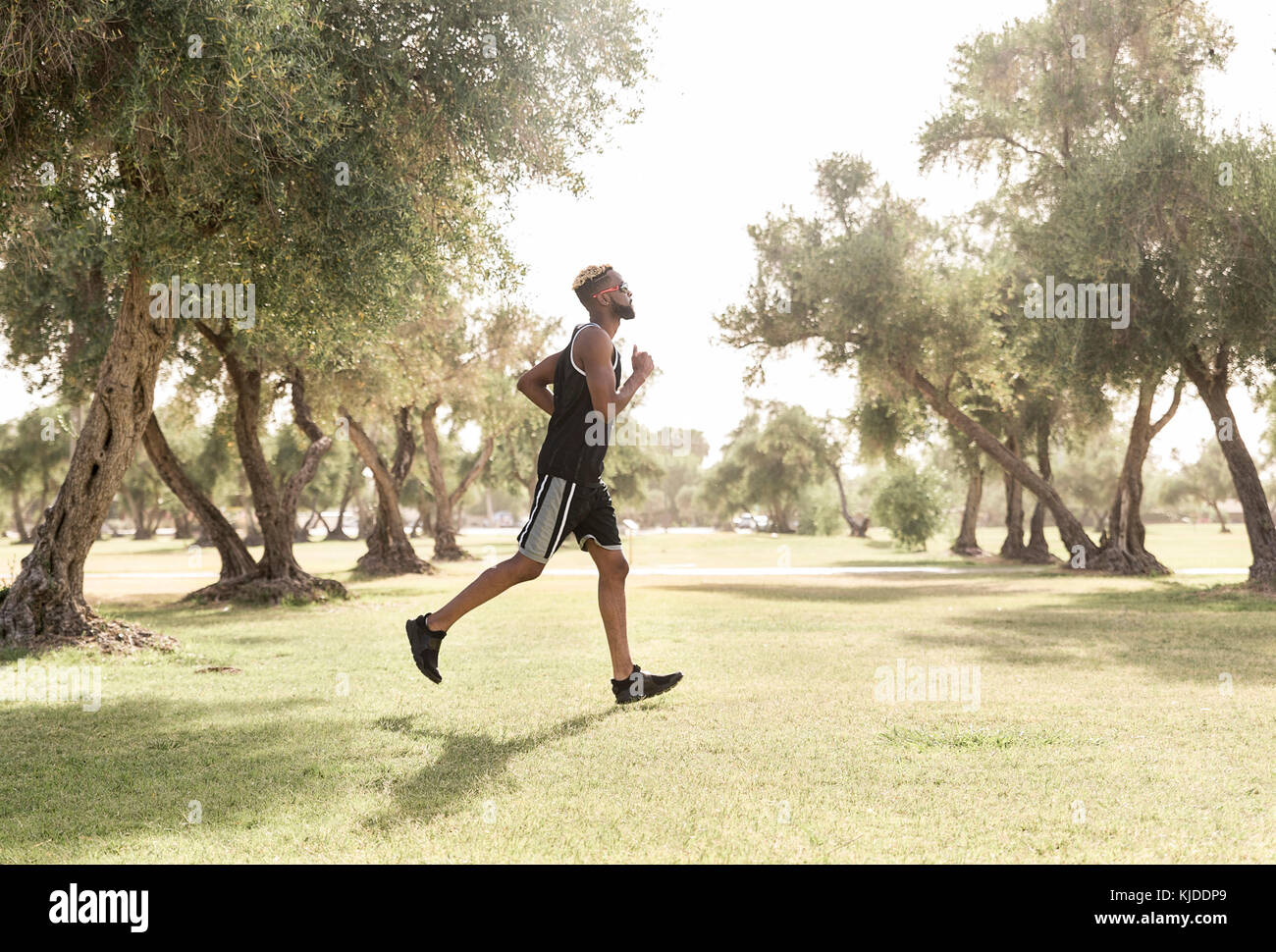 Man running in park hi-res stock photography and images - Alamy