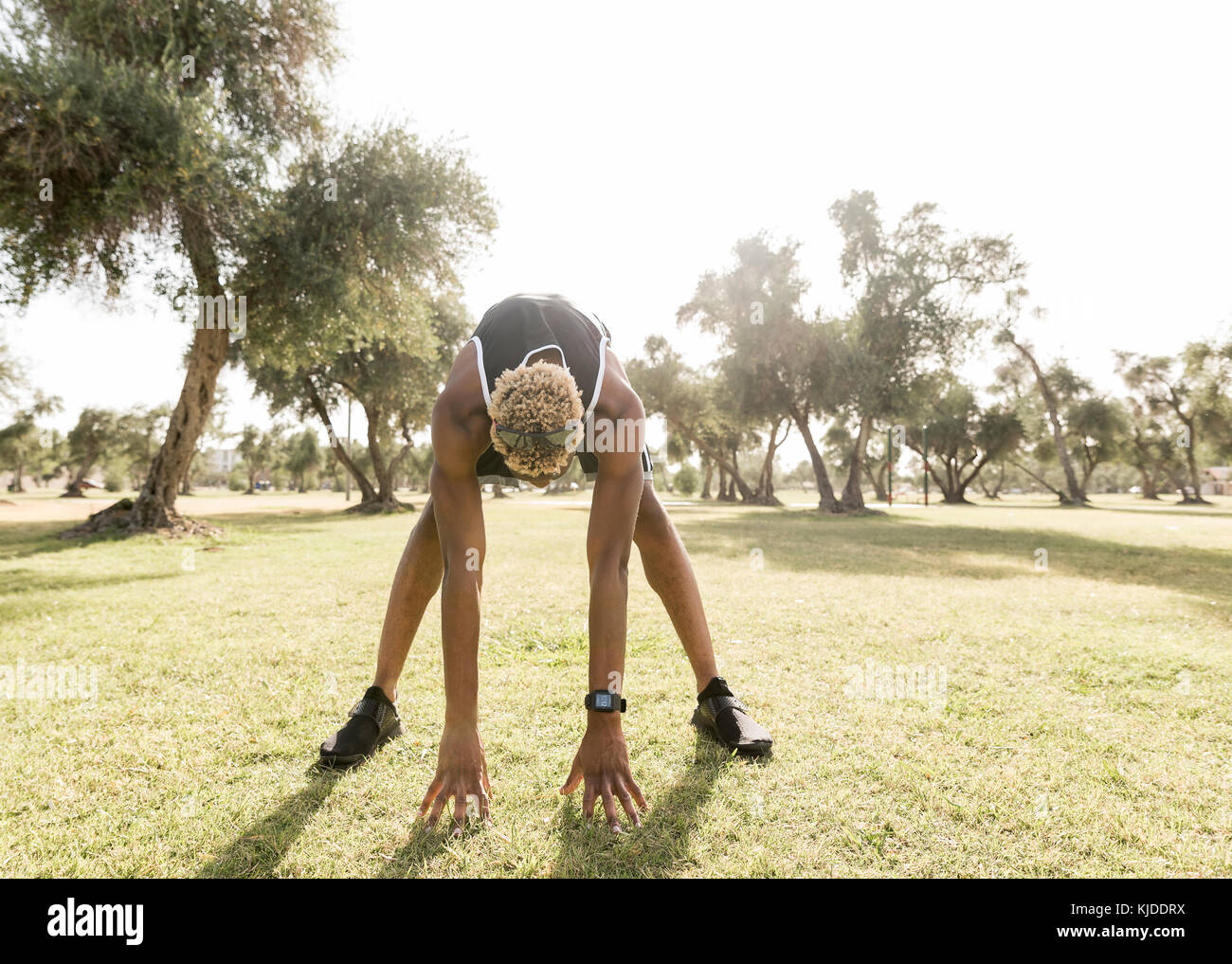 Black man stretching back in park Stock Photo - Alamy