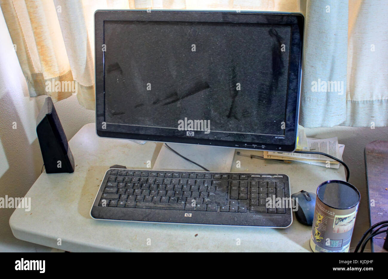 This image shows a dusty computer screen and keyboard, illustrating the ...