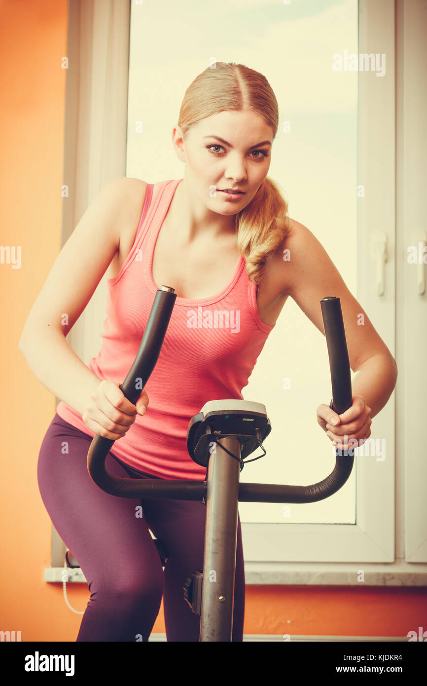 Active human working out on exercise bike stationary bicycle. Sporty ...