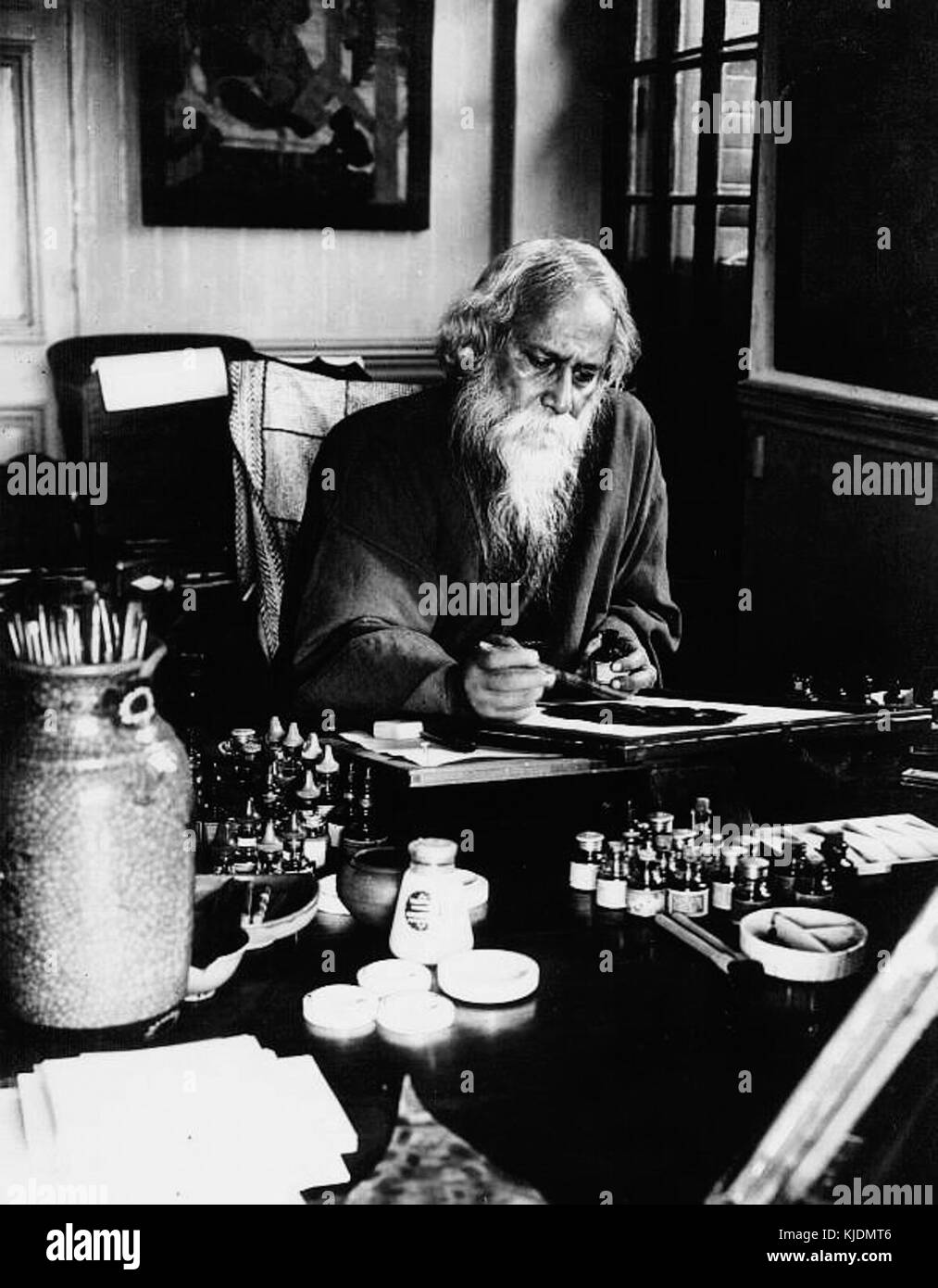 Rabindranath Tagore, renowned Indian poet and artist, is shown working ...