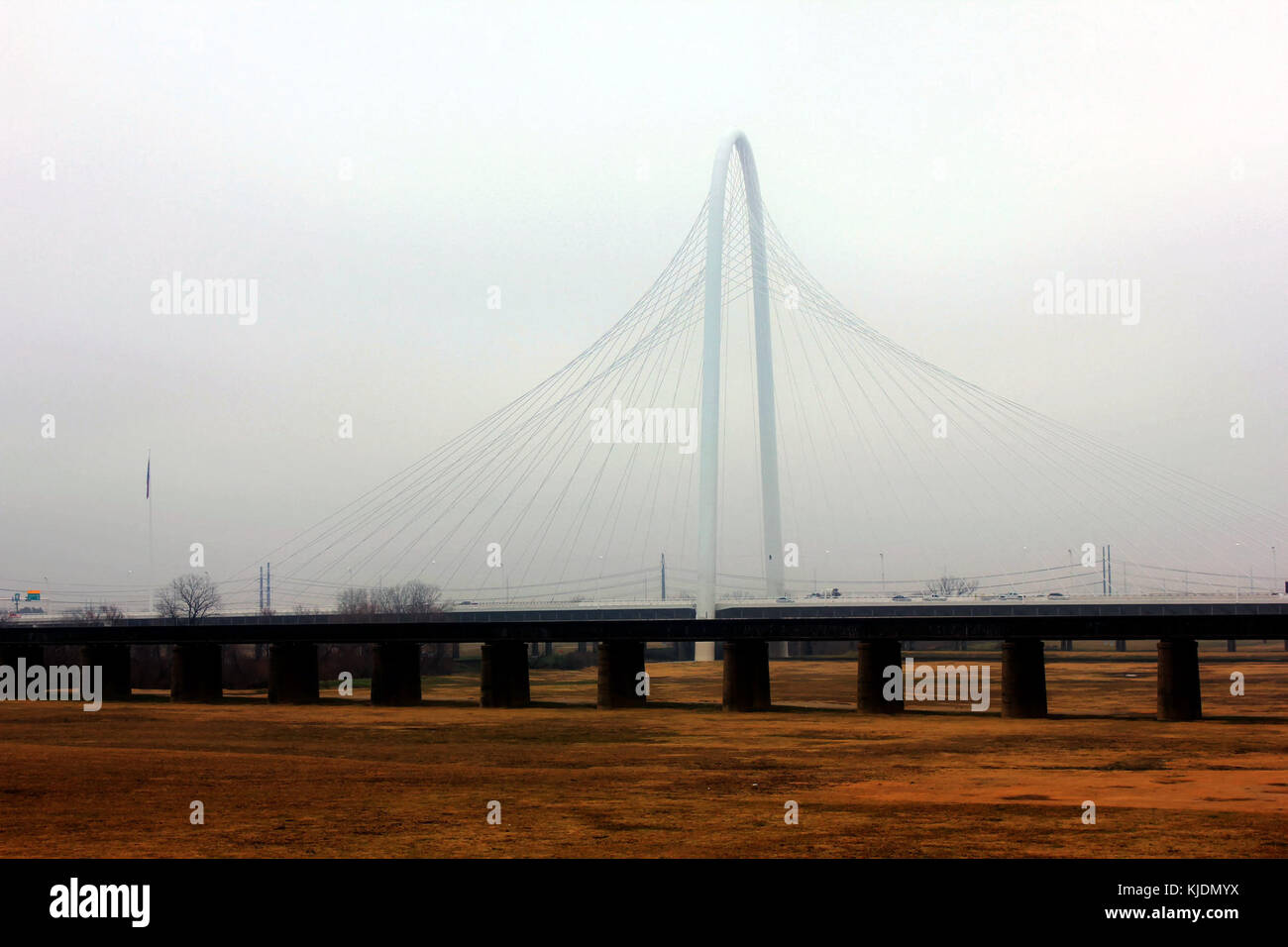 This image shows the famous bridge in Dallas, Texas, shrouded in mist ...