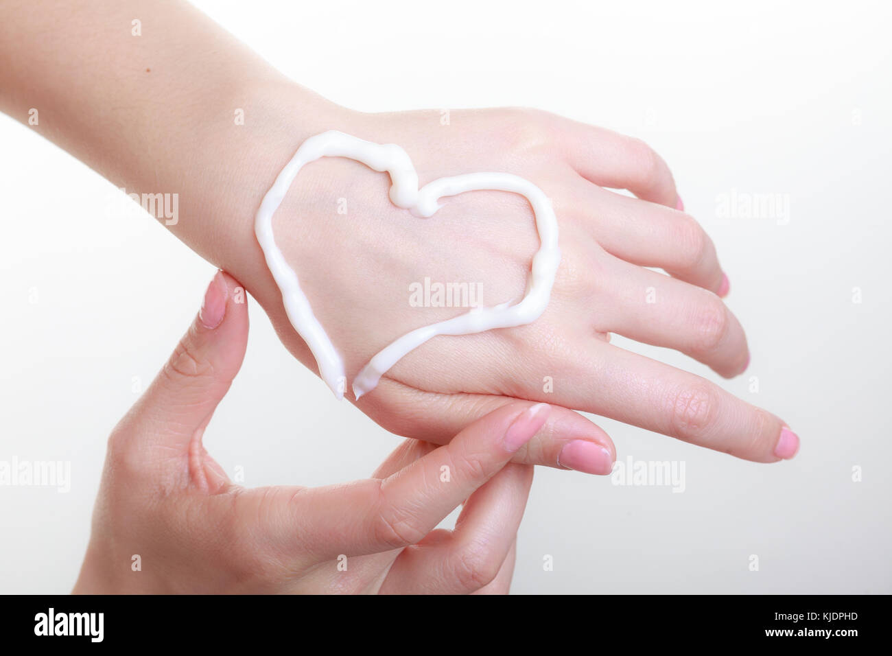 Beauty, cosmetics, concept. Cream on woman hand, heart shape. Studio ...