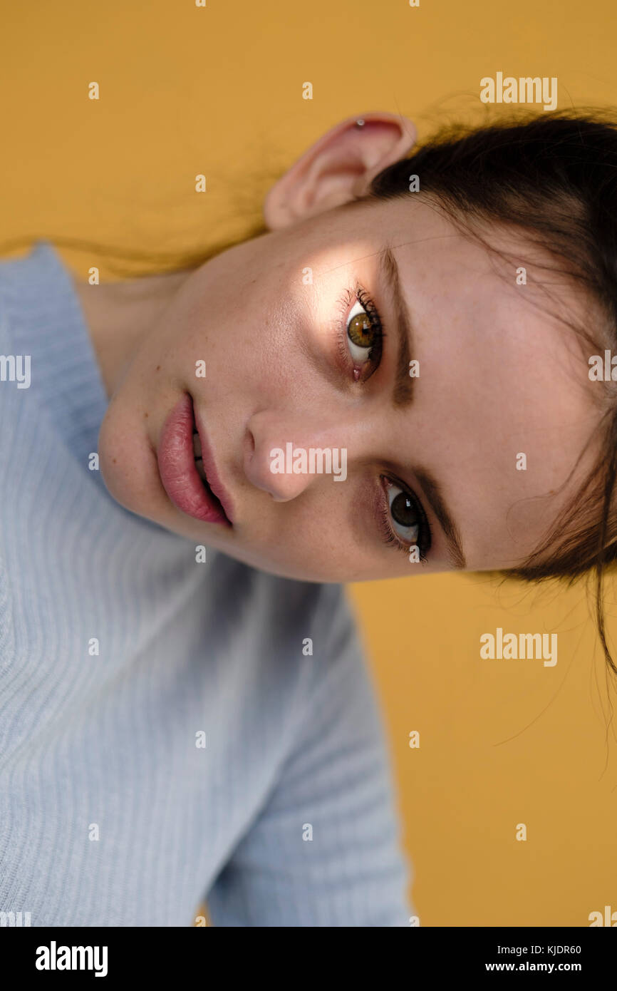 Close up of Caucasian woman tilting head Stock Photo - Alamy