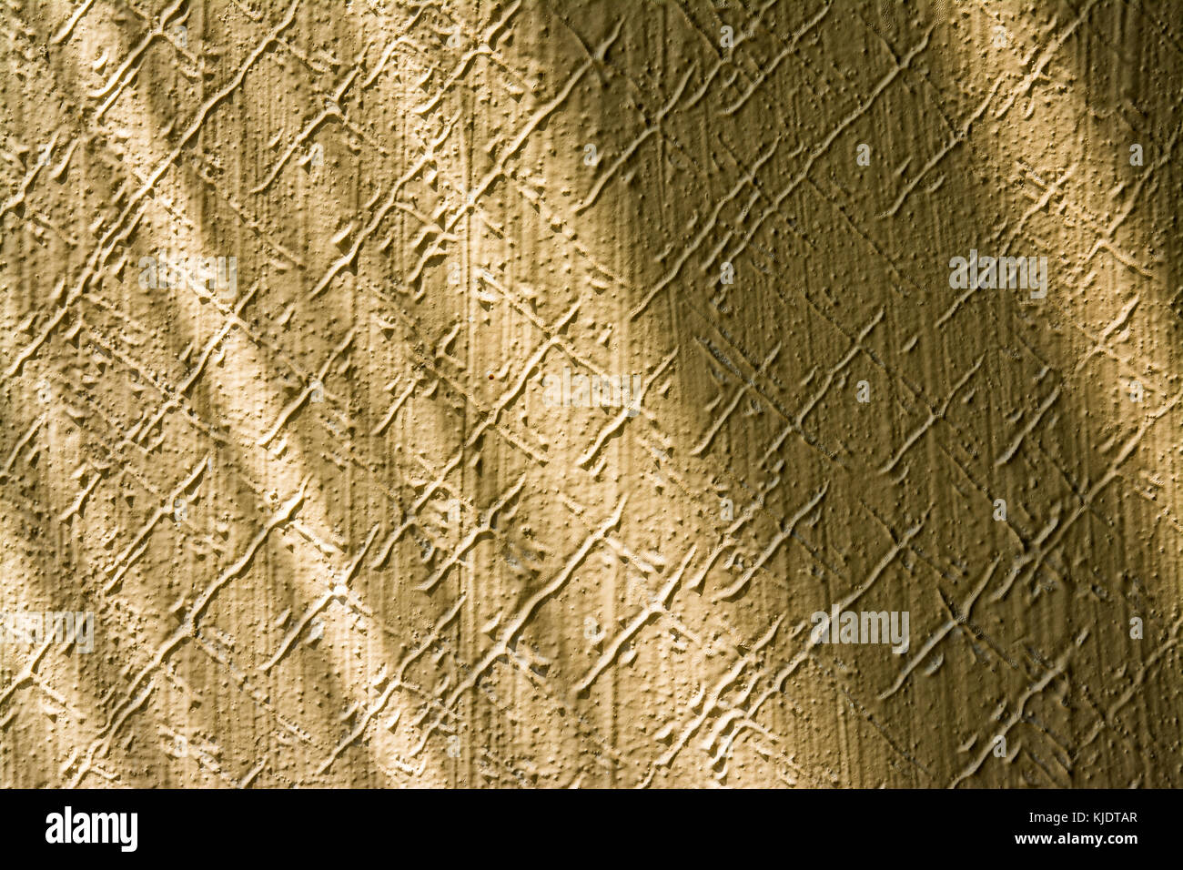 Texture from embossed stucco plaster lit by sunlight with playful ...