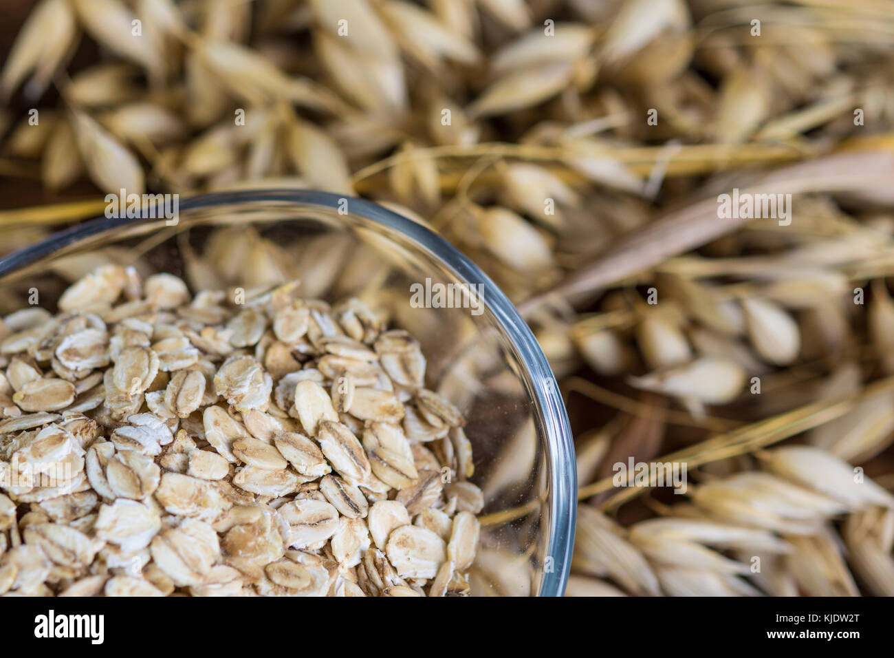 Rolled oats in glass bowl. Beautiful detail of bio oat flakes with ripe ...