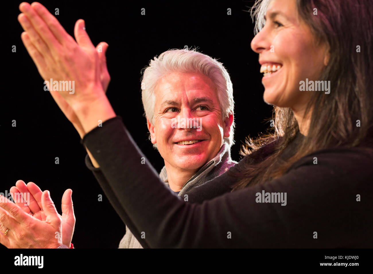 Hispanic man and woman clapping hands Stock Photo - Alamy