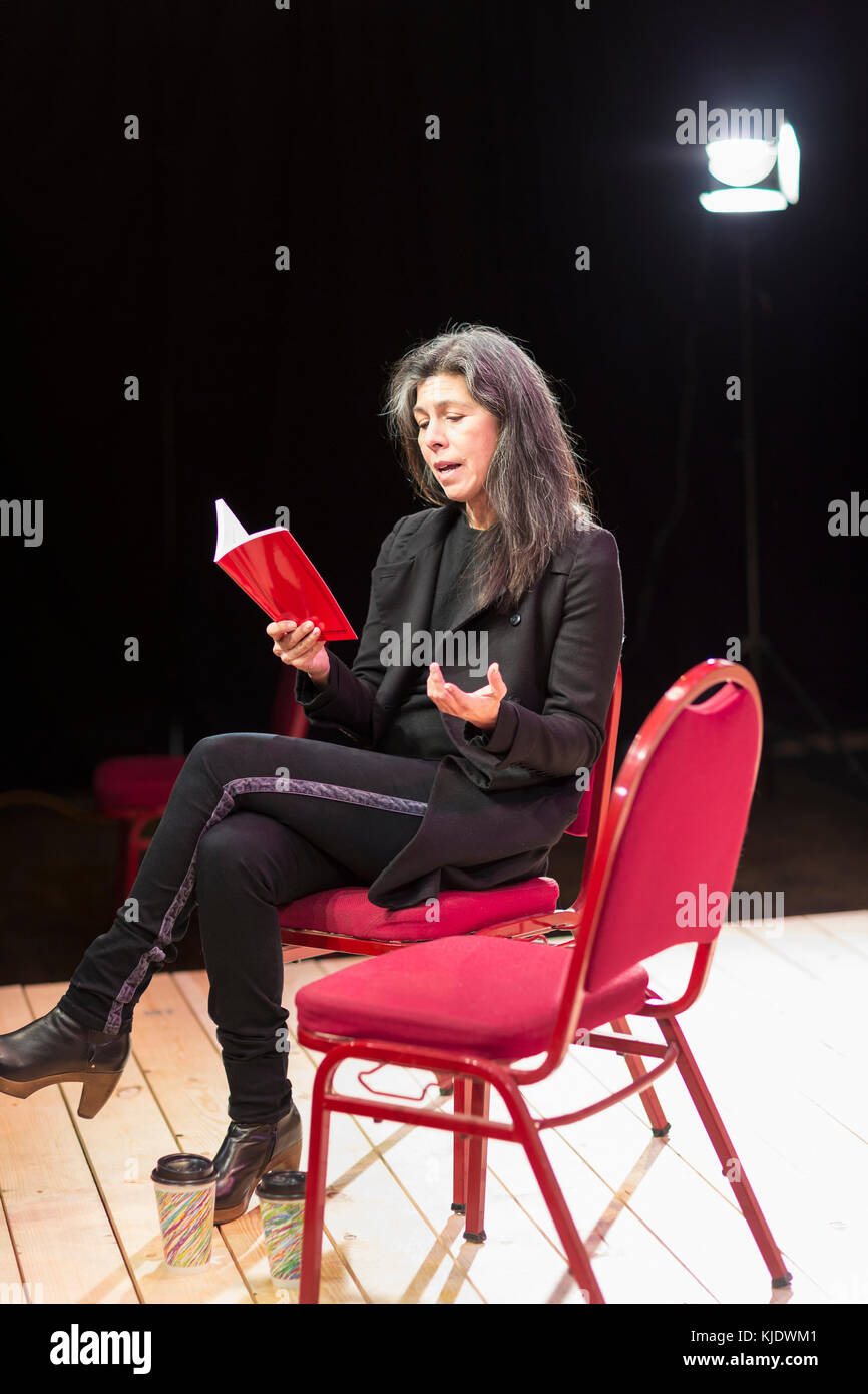 Hispanic woman reading script on theater stage Stock Photo - Alamy