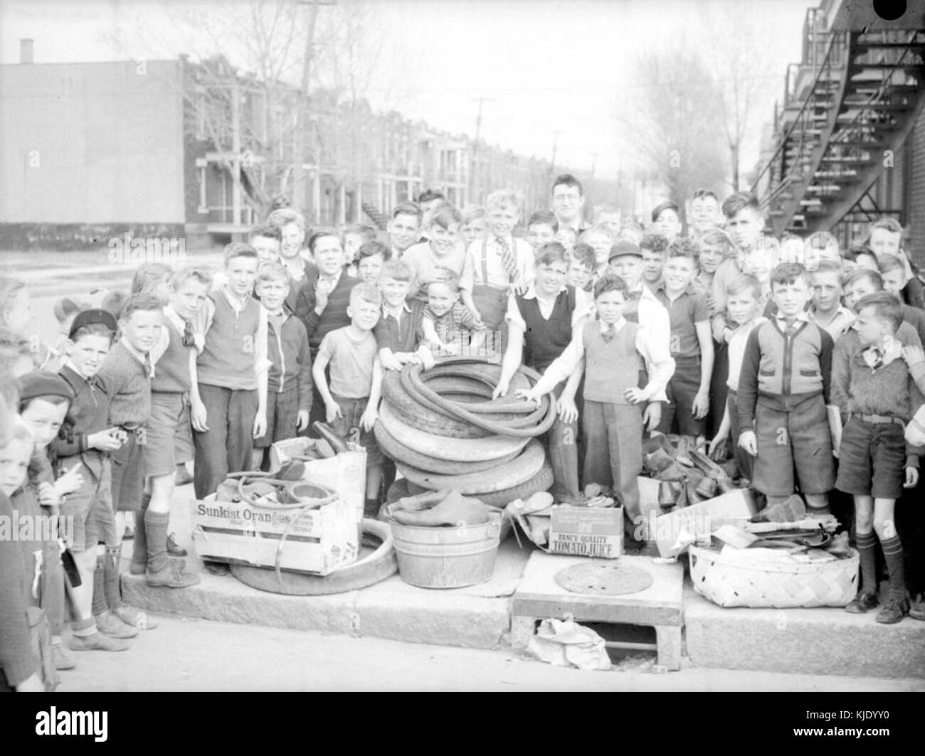 The image shows children from Rosemont, Quebec, collecting rubber for ...