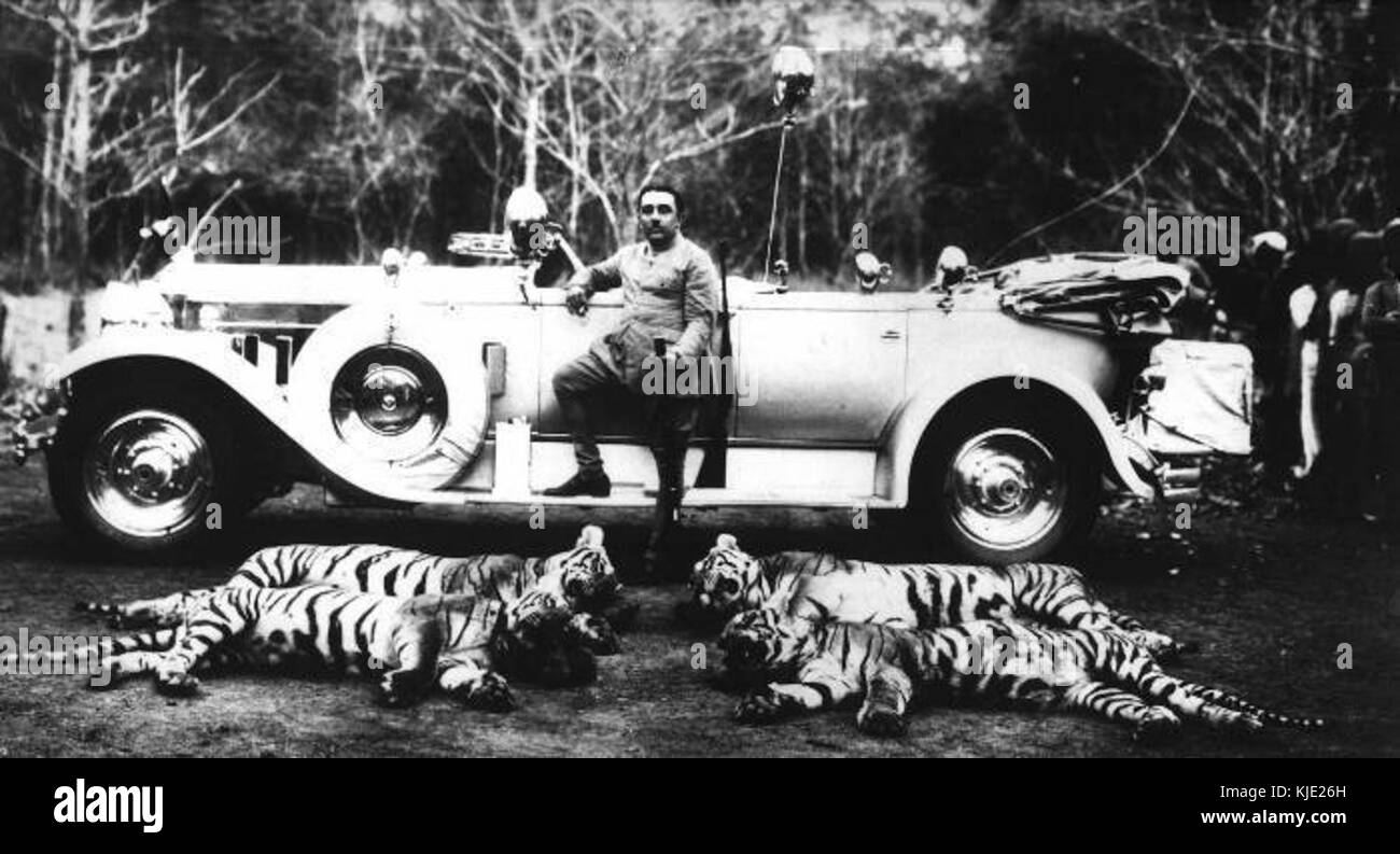 Man posing after hunting tigers in an unknown location in India Stock ...