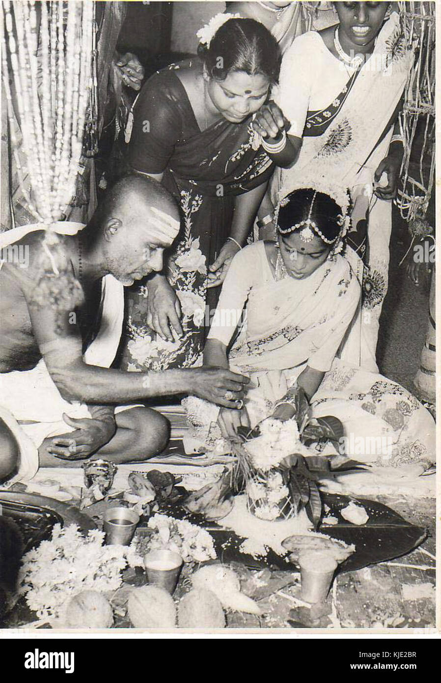 This historical image captures a traditional Tamil wedding ceremony ...