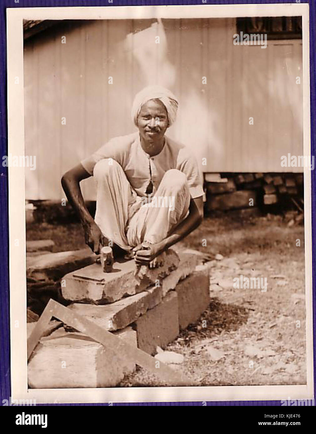 This image shows a stone mason in Assam during the 1920s, capturing the ...