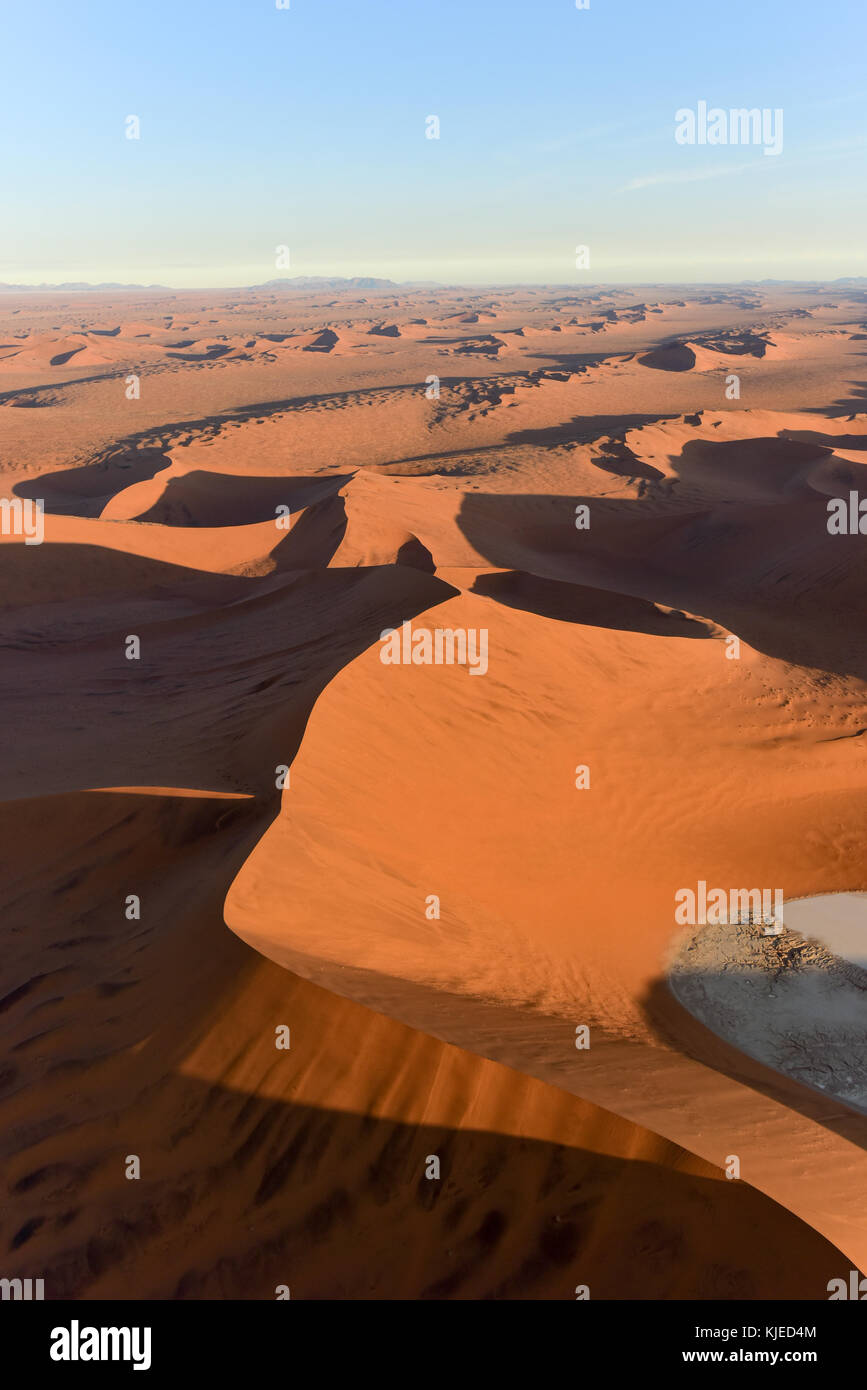 Aerial view of high red dunes, located in the Namib Desert, in the Namib-Naukluft National Park ...