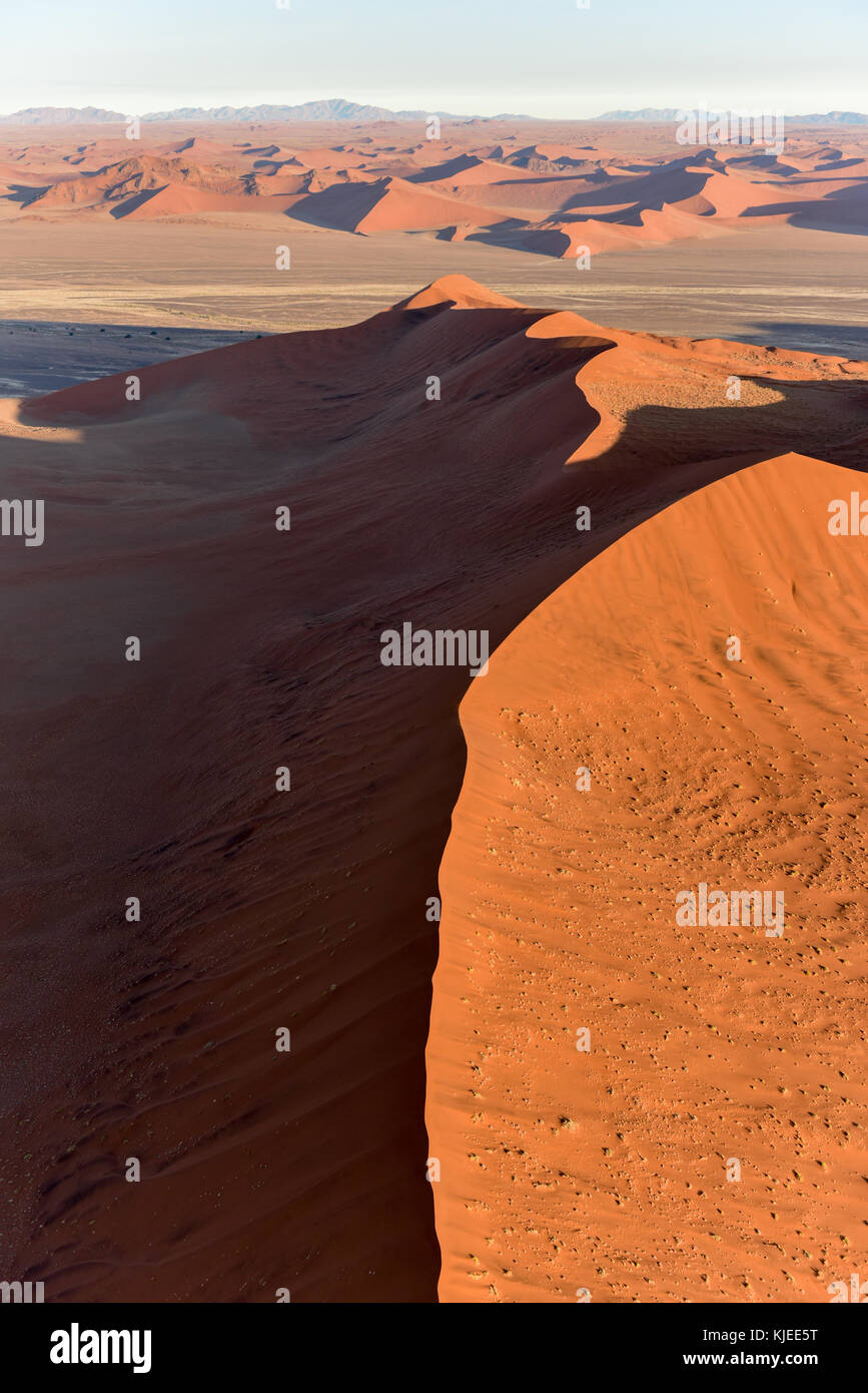 Aerial view of high red dunes, located in the Namib Desert, in the Namib-Naukluft National Park ...