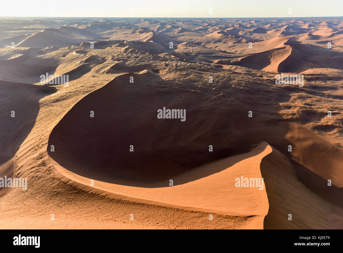 Aerial view of high red dunes, located in the Namib Desert, in the Namib-Naukluft National Park ...