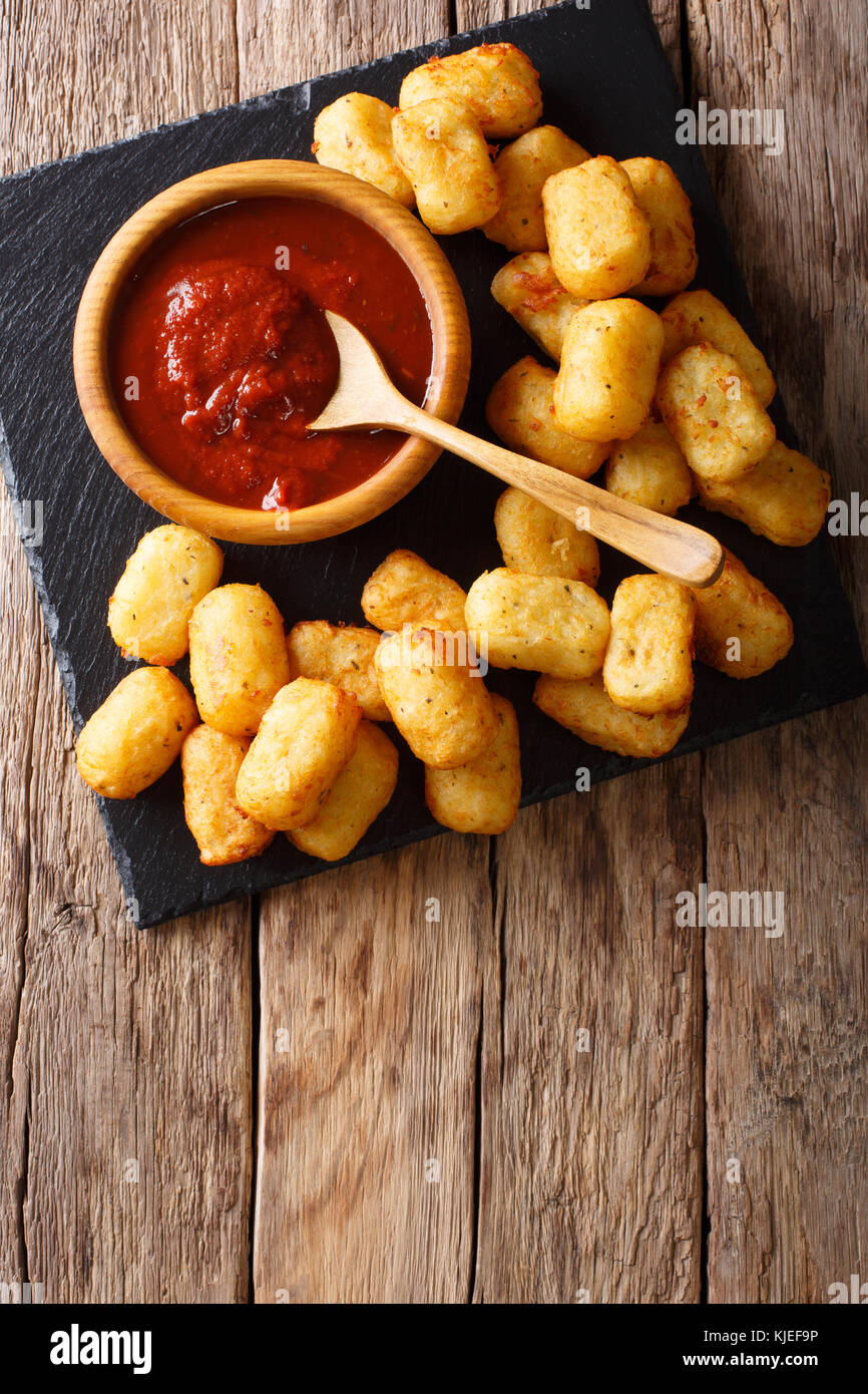 close up of rustic golden potato tater tots and ketchup on the table ...
