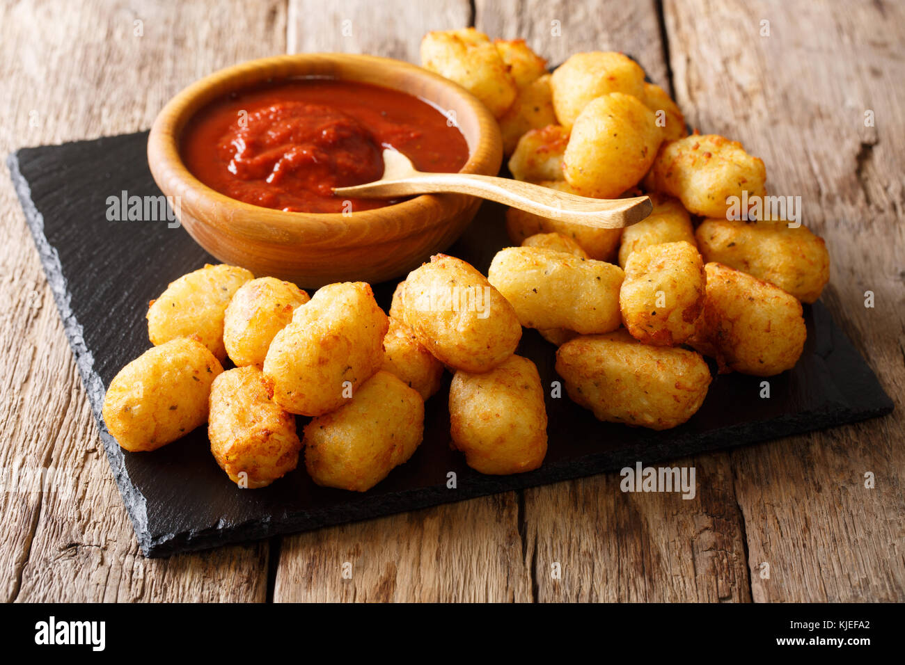 Organic Fried Tater Tots made from fried potato and ketchup close-up on ...