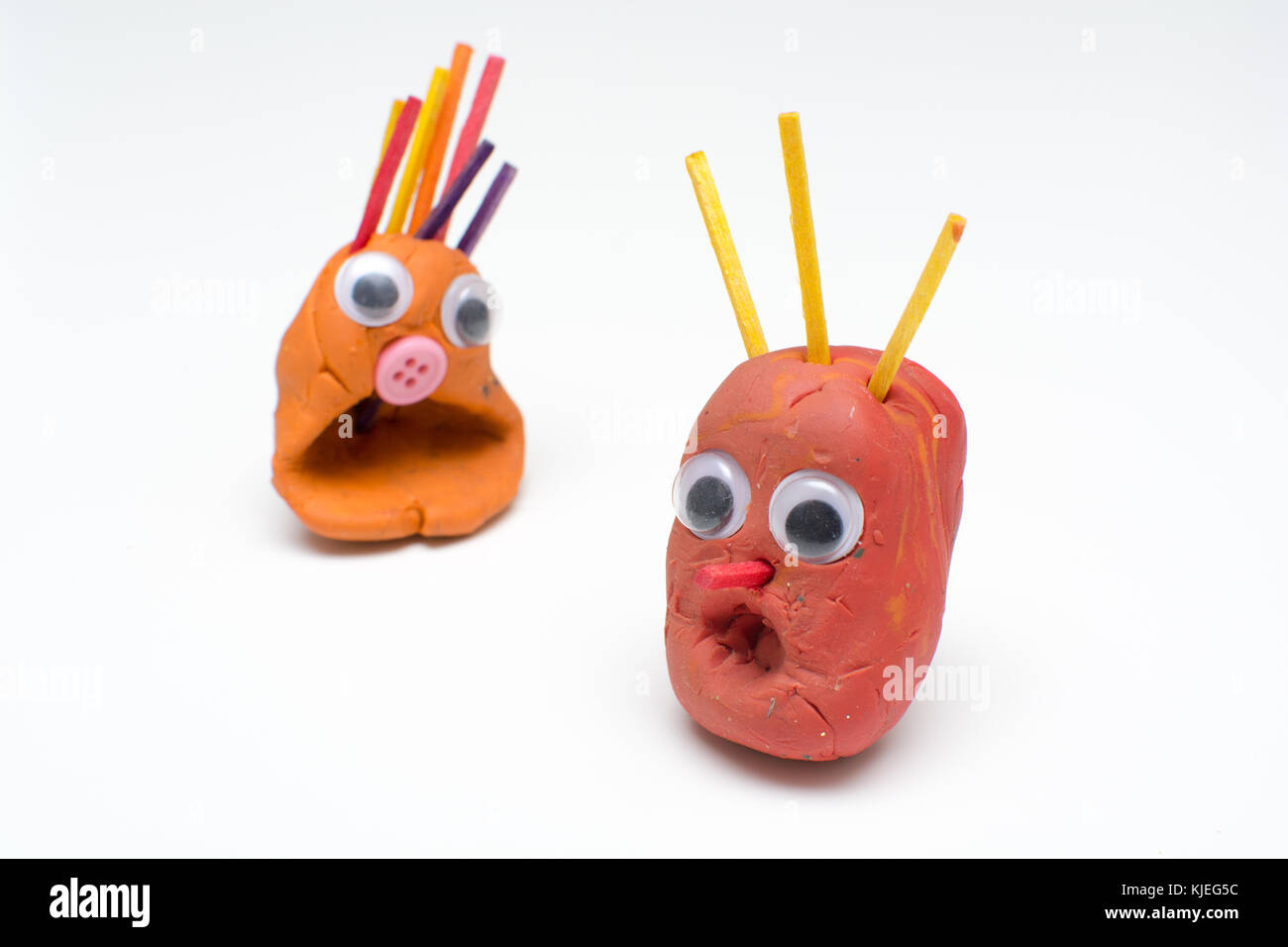 fun modelling clay figures with shocked expression on isolated white ...