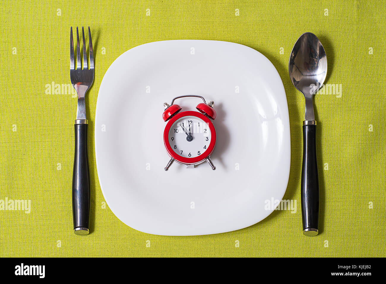 Time to eat concept, clock on plate Stock Photo - Alamy