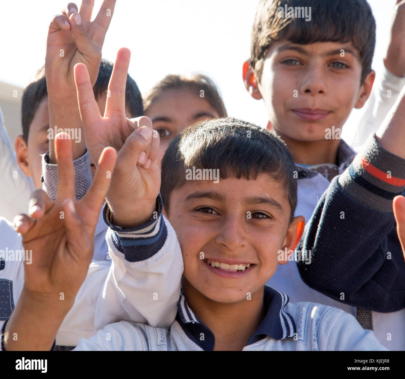 Iraqi students pose for a photo at a primary school in the Village of ...