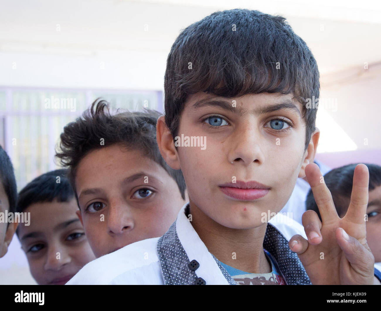 Iraqi students pose for a photo at a primary school in the Village of ...