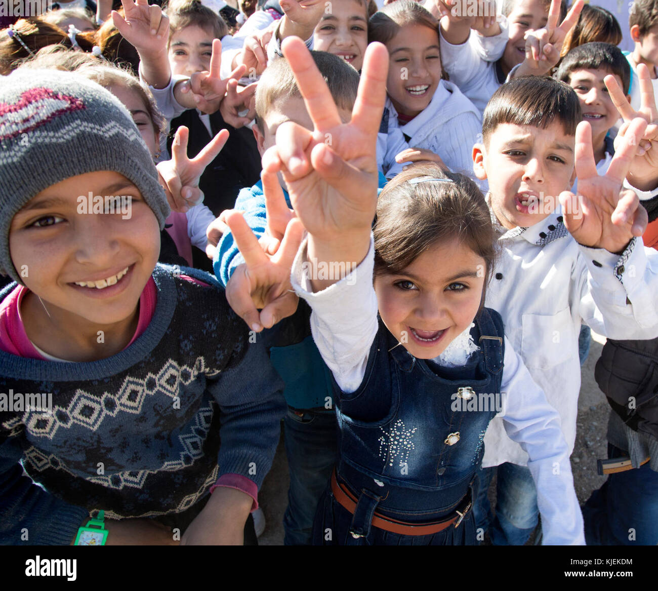 Iraqi students pose for a photo at a primary school in the Village of ...